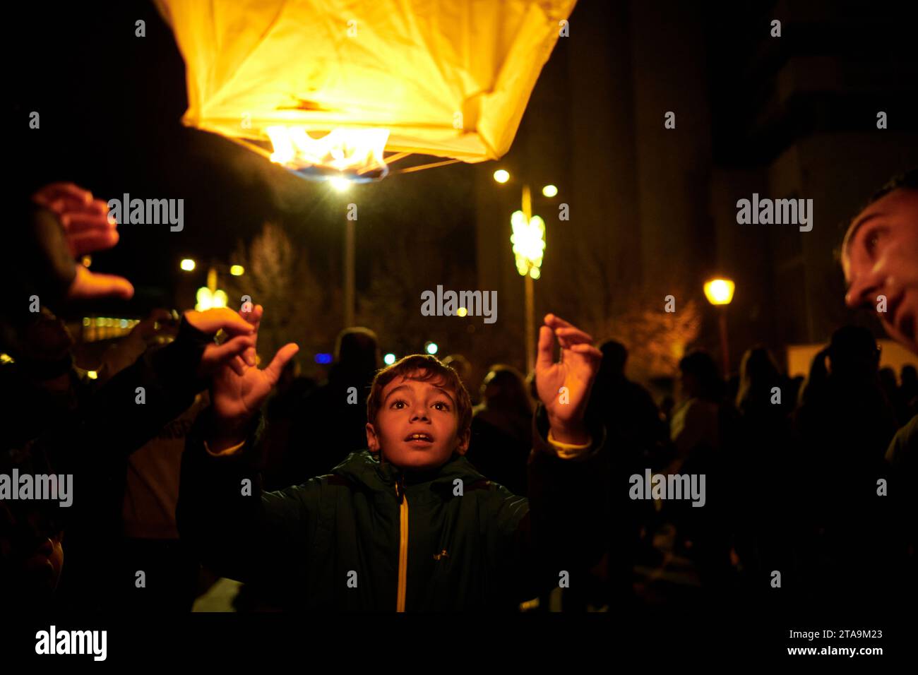 A child is surprised to see his lantern flying. The Pamplona City ...
