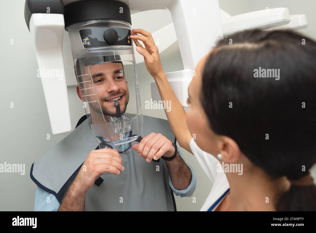 Patient standing in x-ray machine. Panoramic radiography at ...