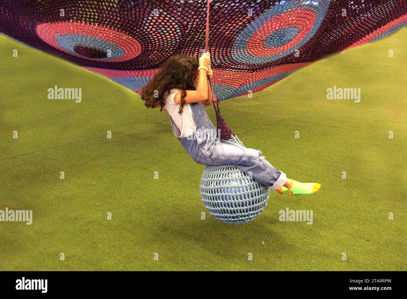 9 year old Latina girl with brunette curly hair plays and has fun on ...