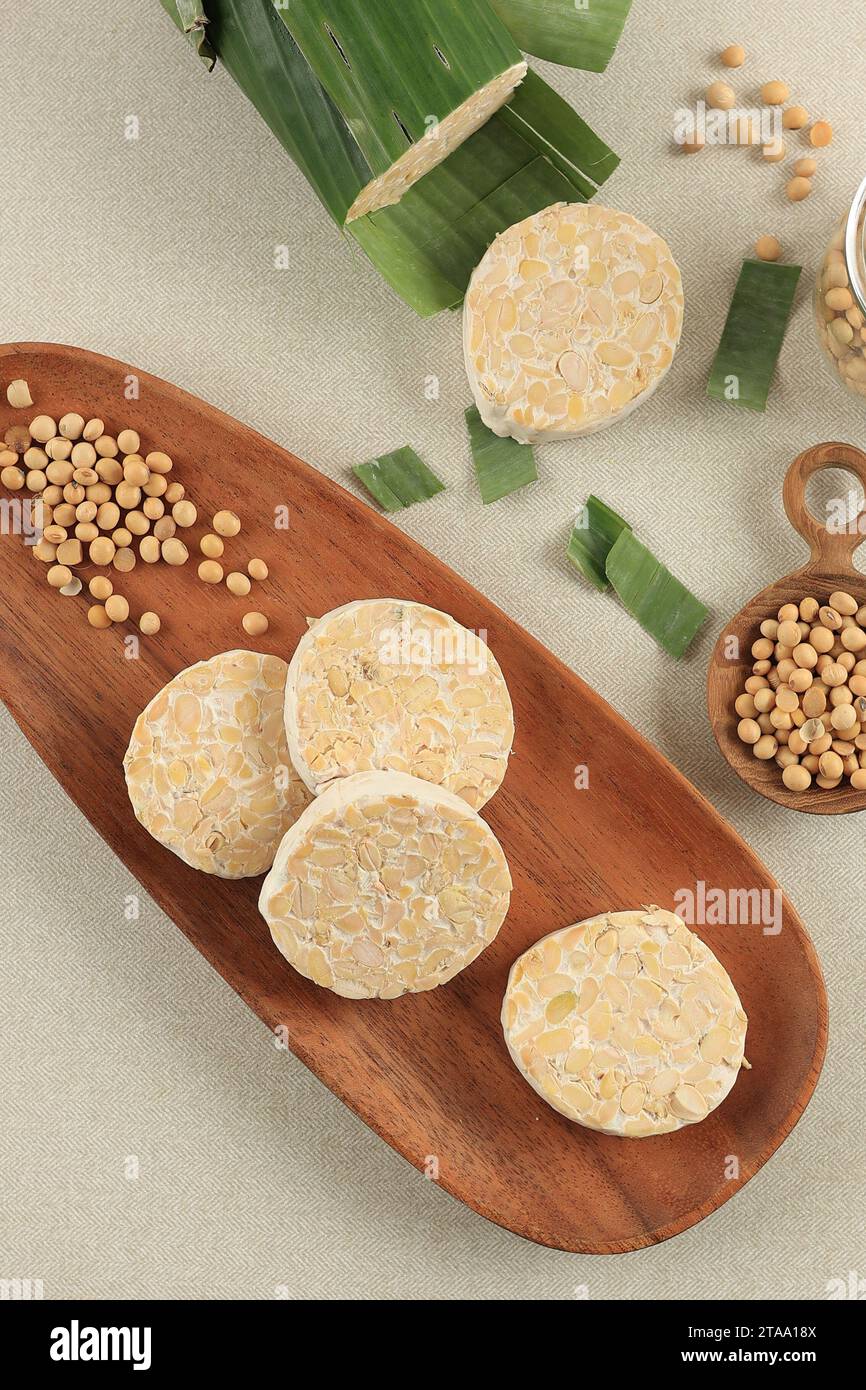 Raw Tempeh or Tempe Mentah, Slices in Wooden Oval Plate. Tempe is ...