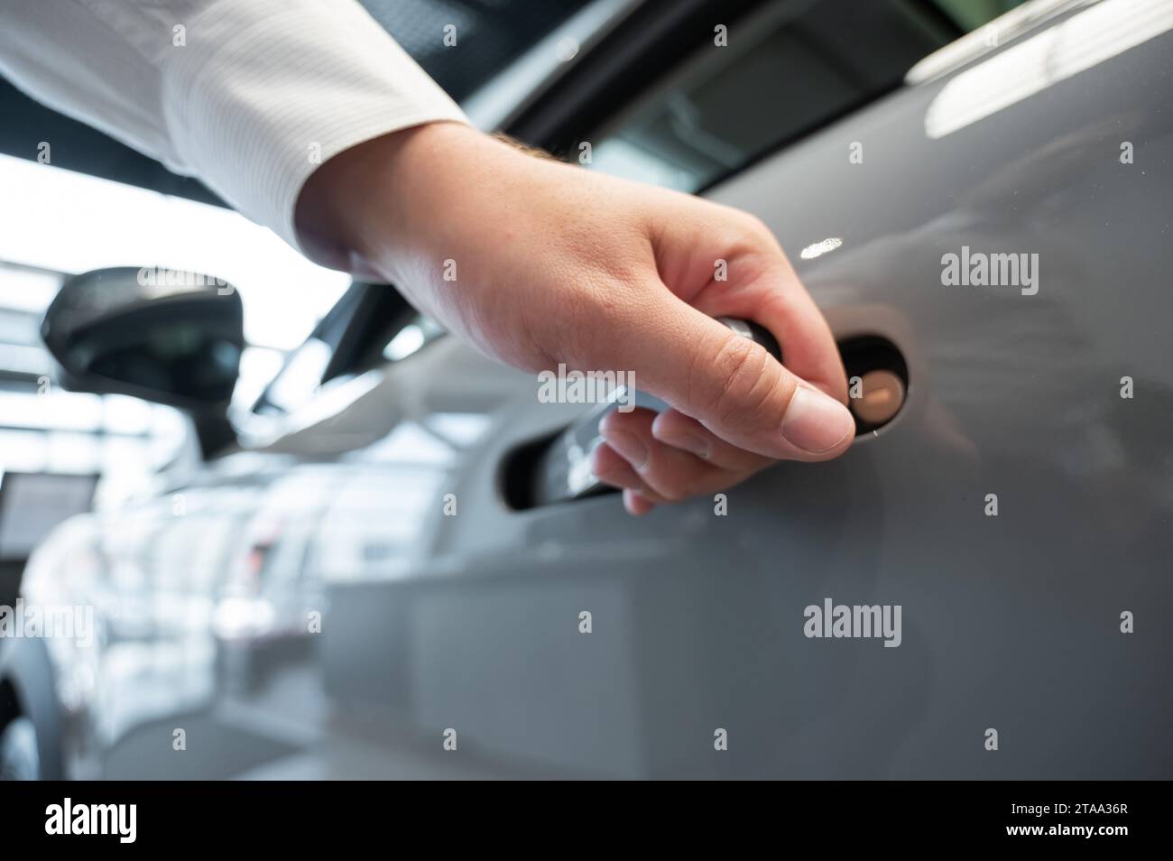 A man opens a car door with a fingerprint. Integrated handle Stock ...