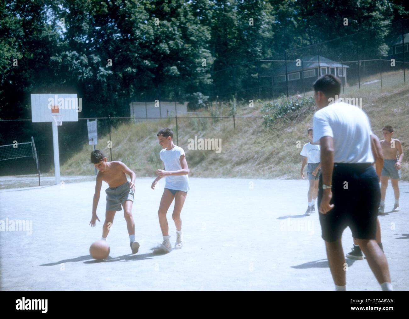 1960'S: Kids play basketball in a game of skins versus shirts outside ...