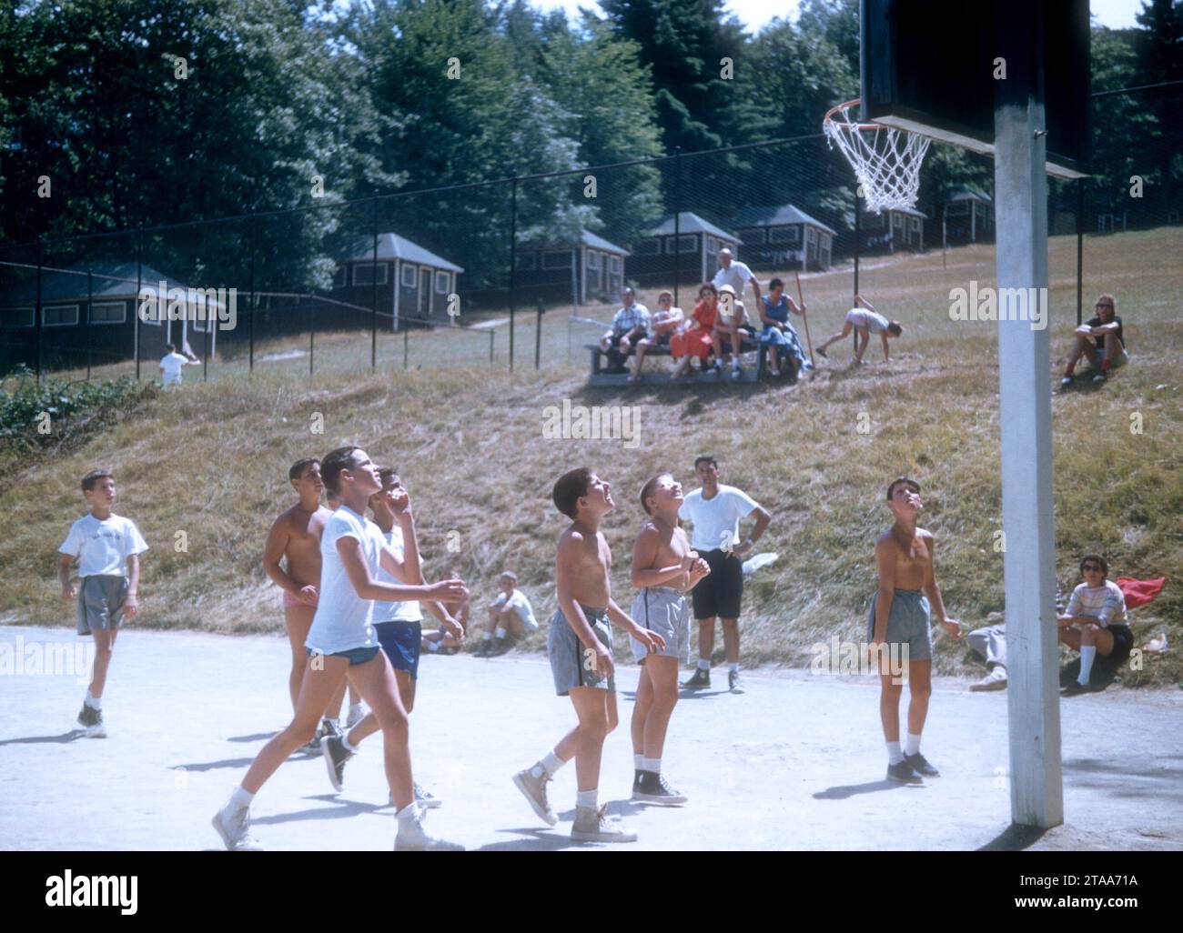 1960'S: Kids play basketball in a game of skins versus shirts outside at Camp Ha-Wa-Ya circa ...