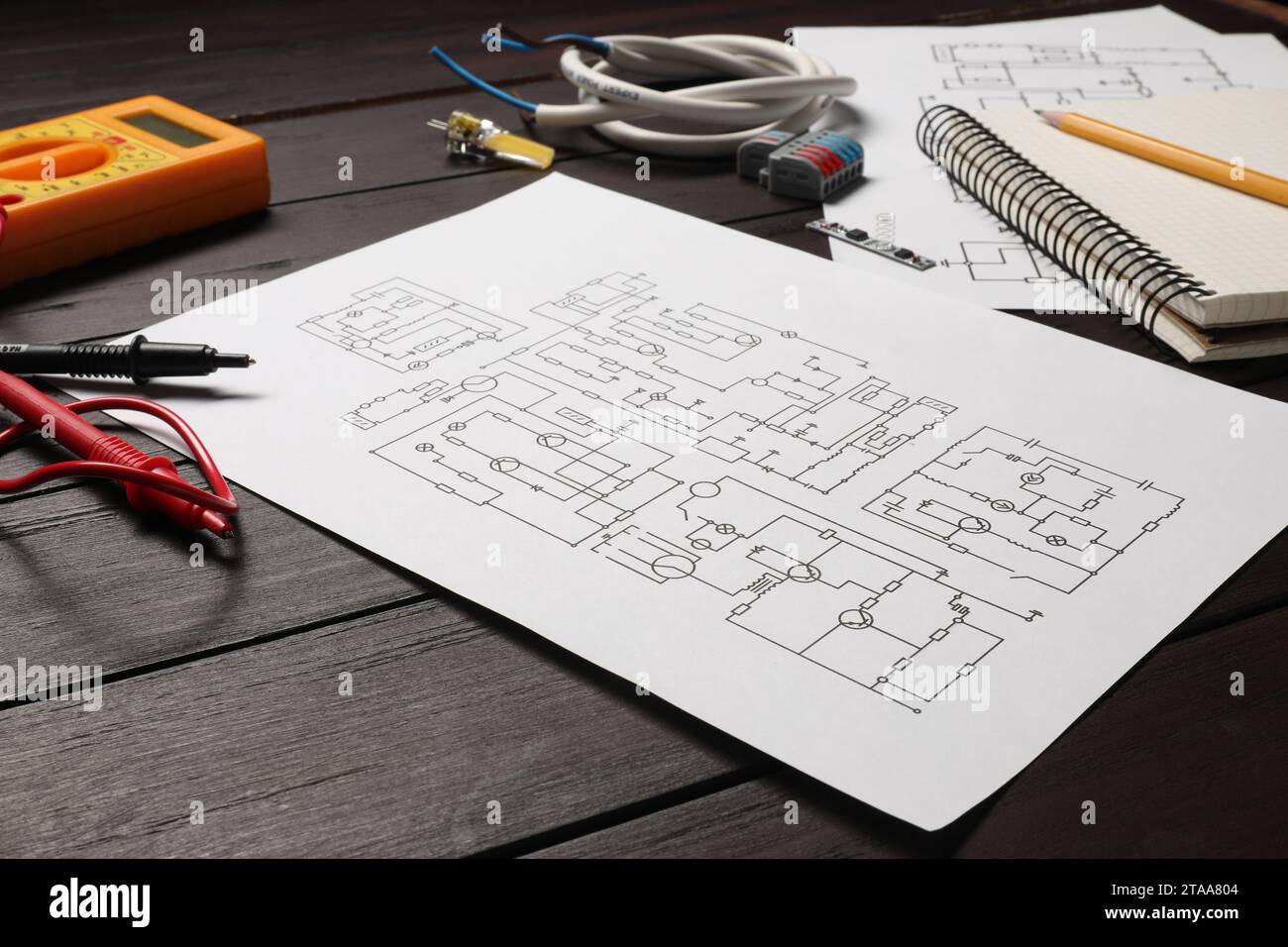 Wiring diagrams, office stationery, wires and digital multimeter on ...
