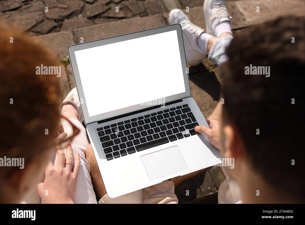 Students studying with laptop together outdoors, back view Stock Photo ...