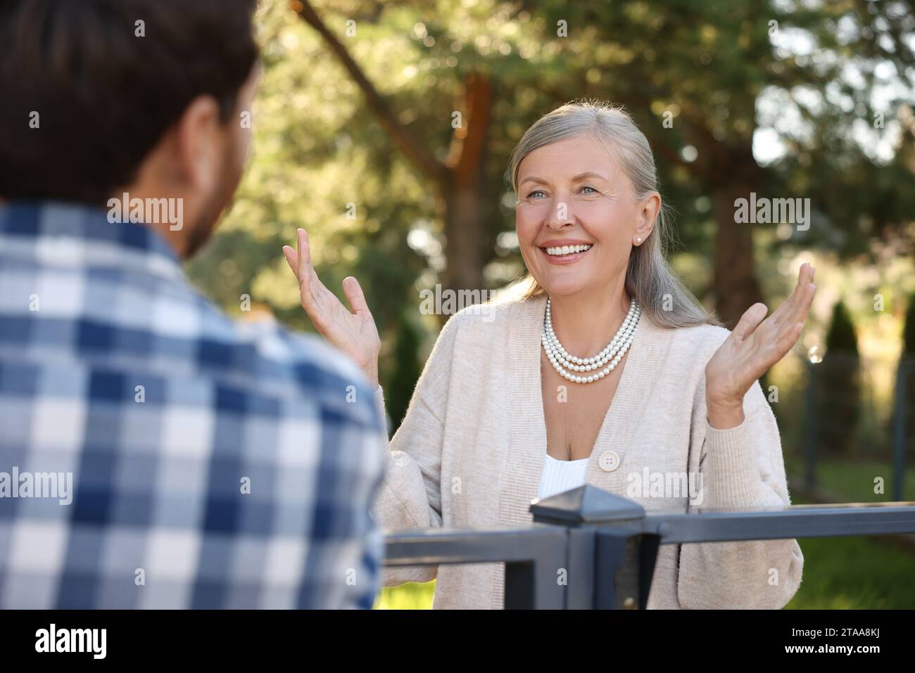 Neighbours talking fence hi-res stock photography and images - Alamy