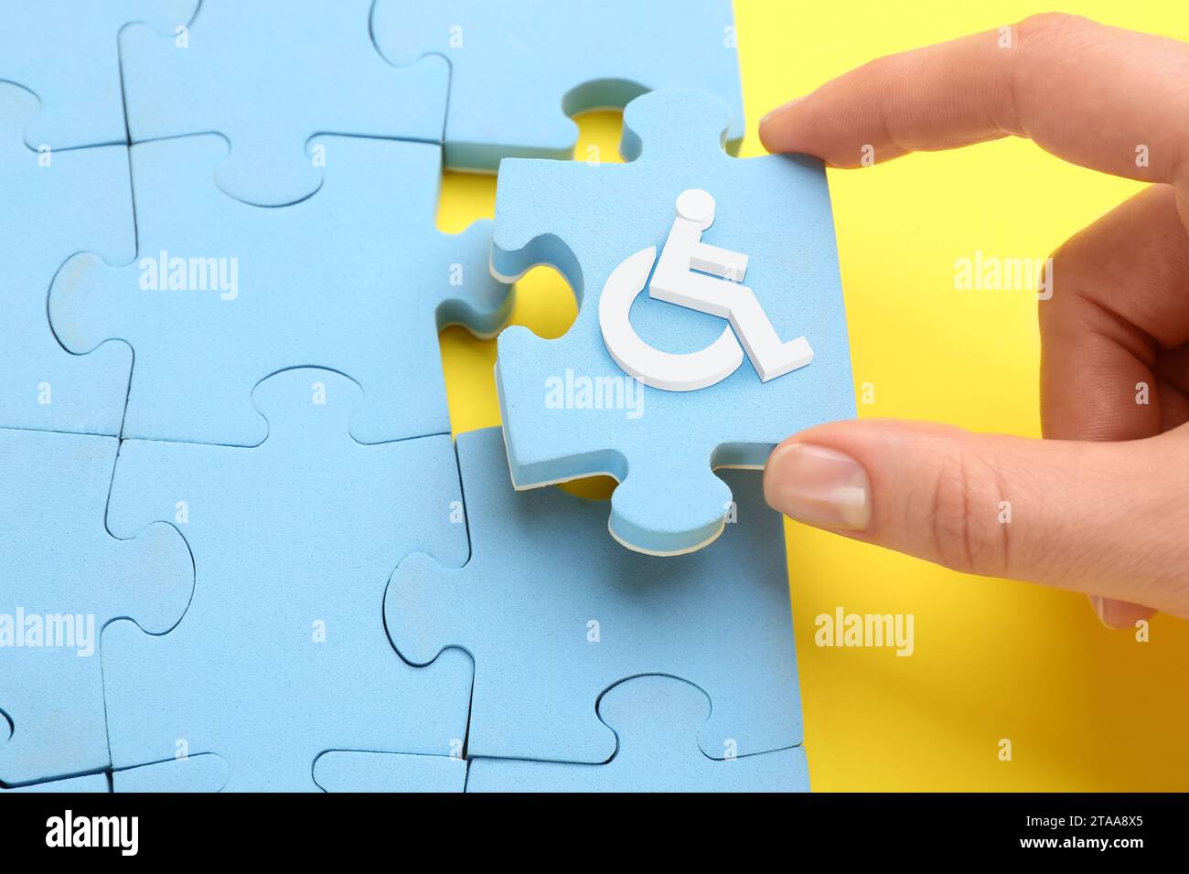 Inclusion concept. Woman putting light blue puzzle with international ...