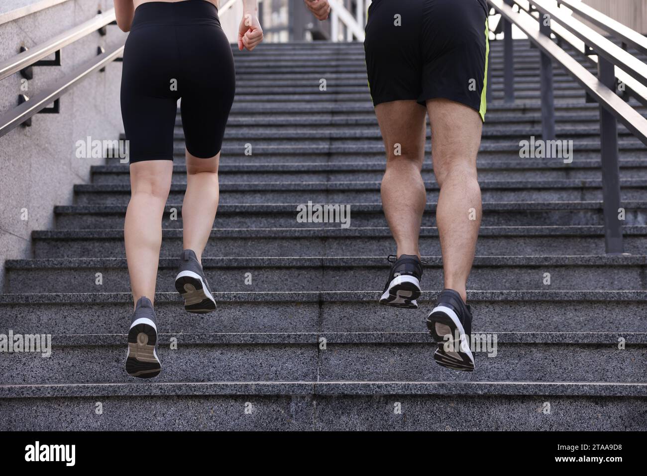 Sporty woman running up steps hi-res stock photography and images - Alamy