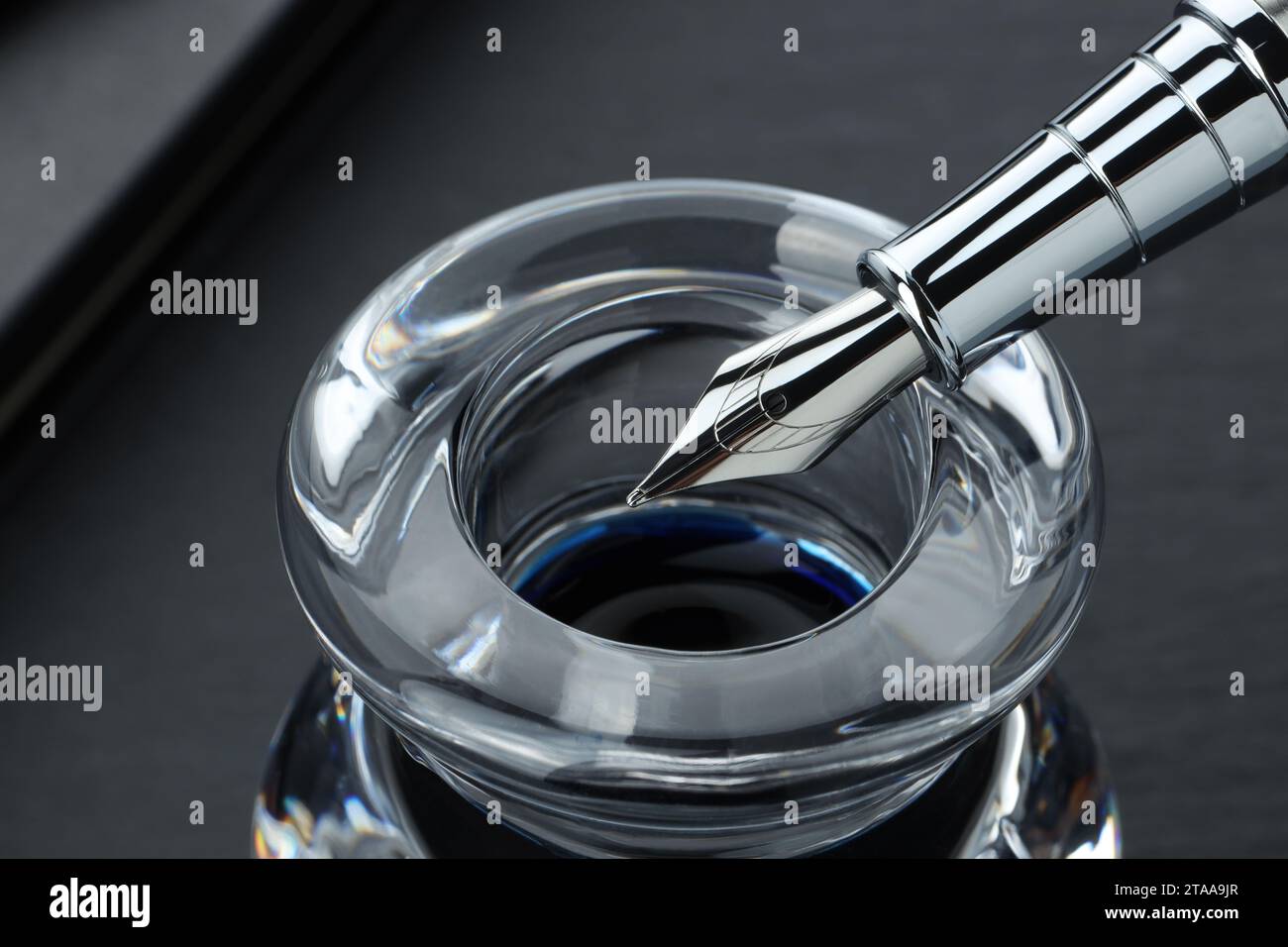 Inkwell with fountain pen on grey table, closeup Stock Photo - Alamy