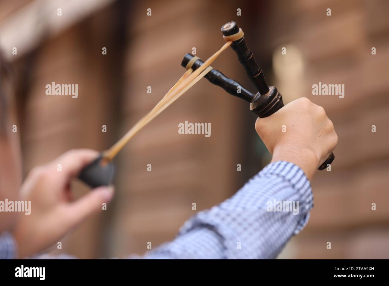 Little boy playing with slingshot outdoors, closeup Stock Photo - Alamy
