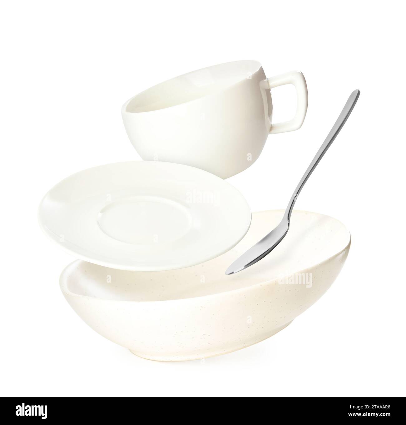 Clean dishes, cup and spoon falling on white background Stock Photo - Alamy
