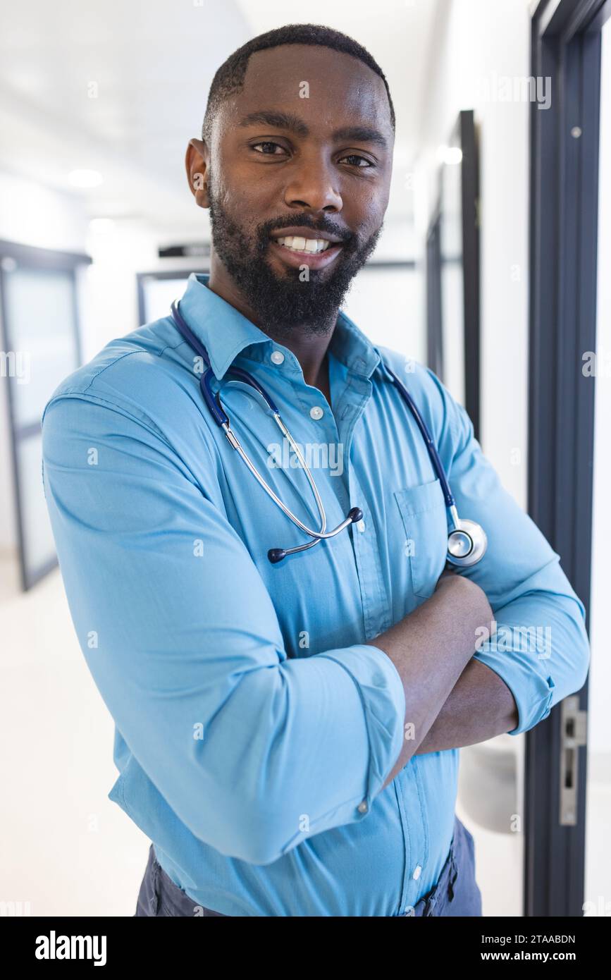 Portrait of happy african american male doctor wearing blue shirt in ...