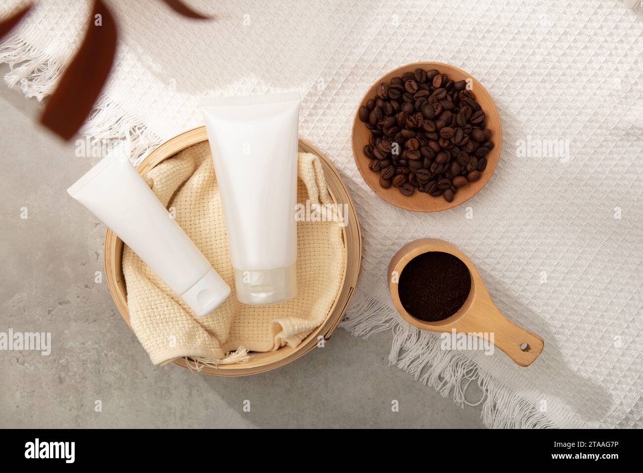 Advertising photo with cosmetic tube mockup decorated with coffee beans ...