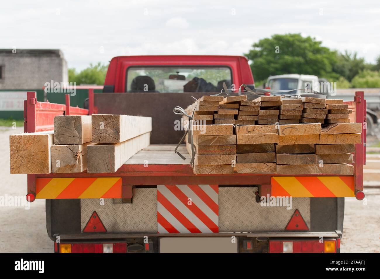 Wooden planks bars immersed in car trailer. Wood Industry ...