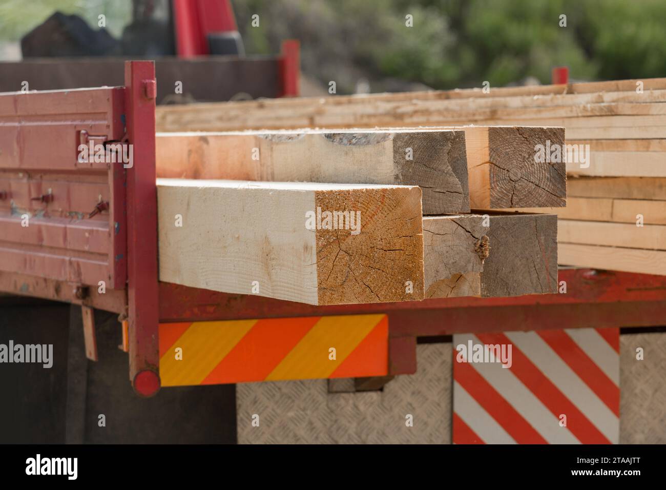 Close-up of wooden planks bars immersed in car trailer. Wood Industry ...