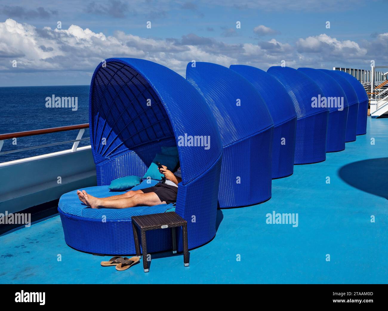 South Pacific Cruise / Cruise ship passenger using his mobile phone and ...