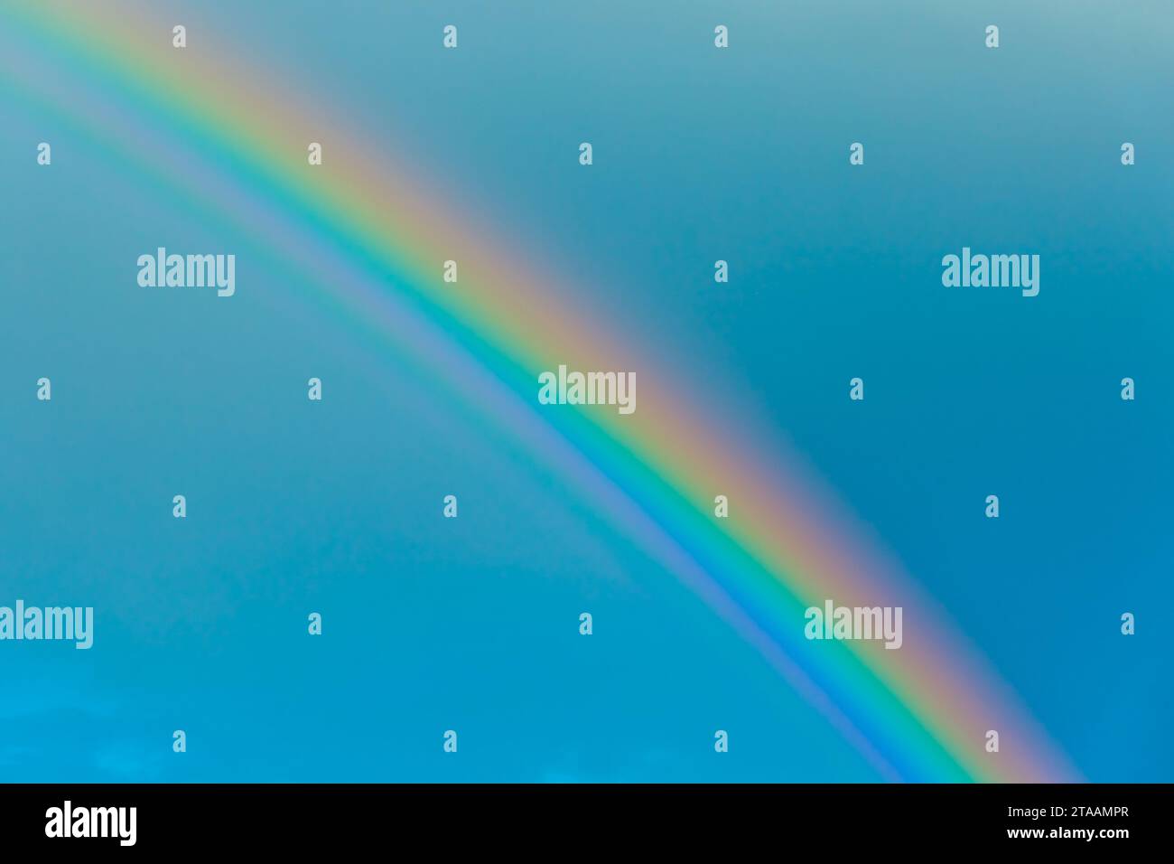Colorful bright rainbow natural phenomenon on the background of blue ...