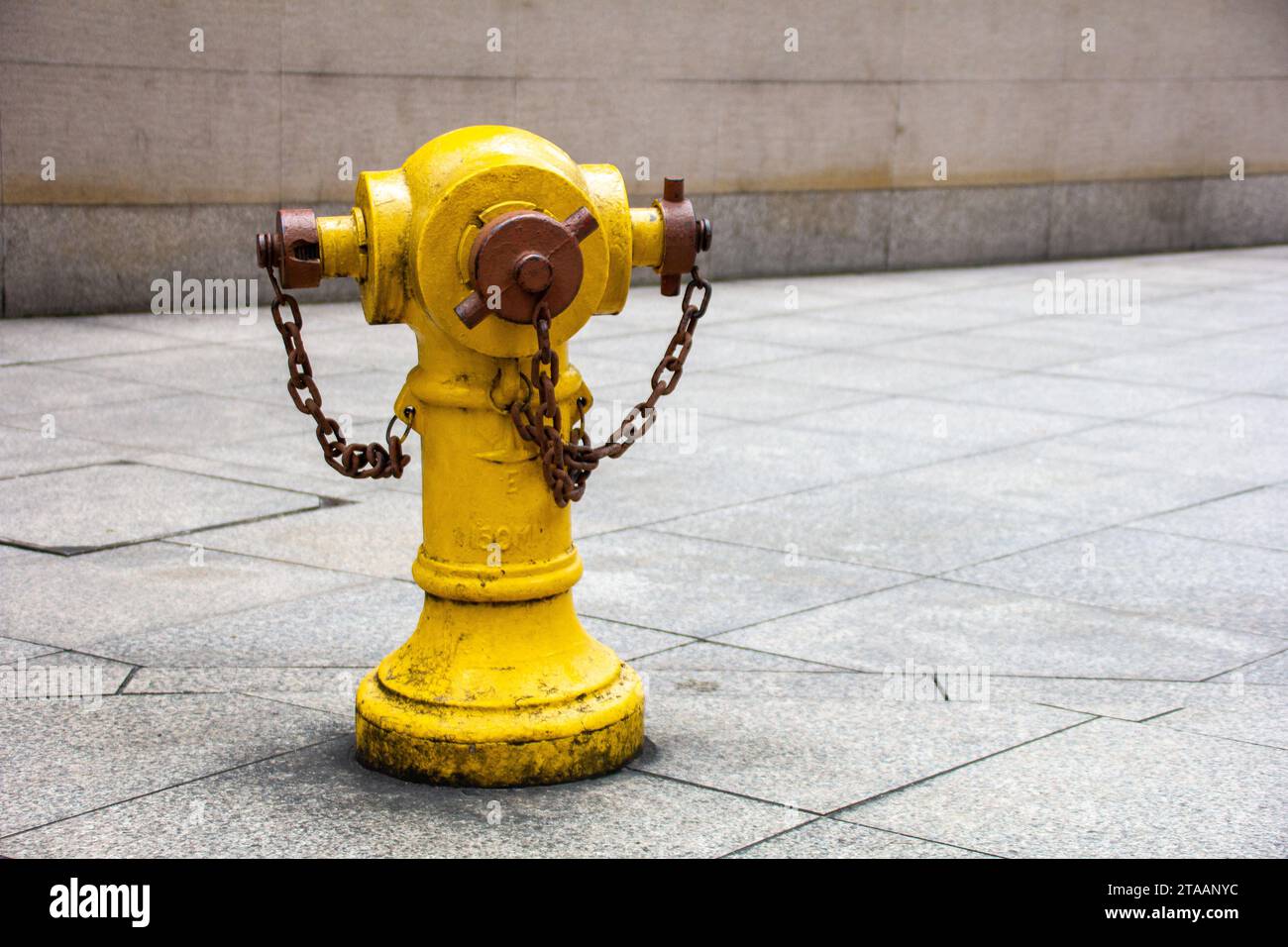 Yellow fire hydrant stand post Stock Photo - Alamy