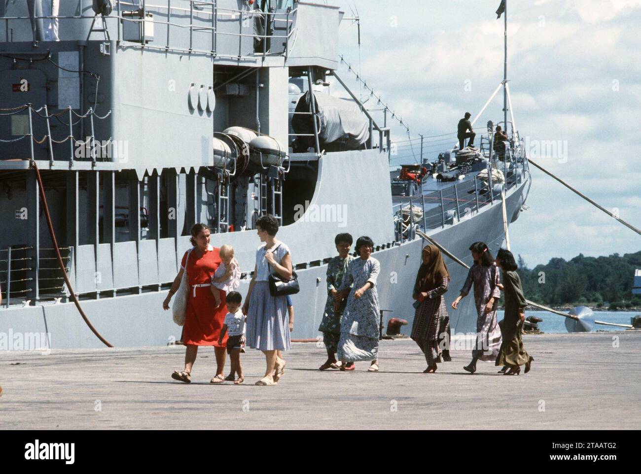 Visitors arrive for a tour of the guided missile destroyer USS HENRY B ...