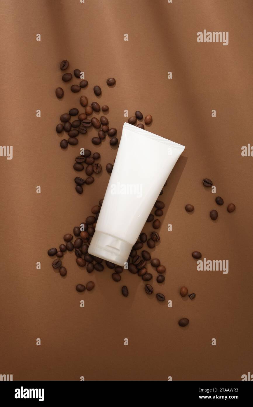 Against the brown background, white plastic tube container for mask or ...