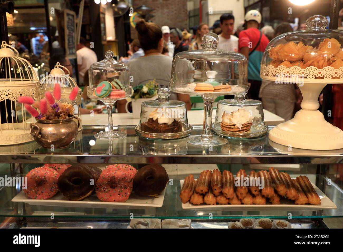 Desserts display on the counter of a open kitchen restaurant inside of ...