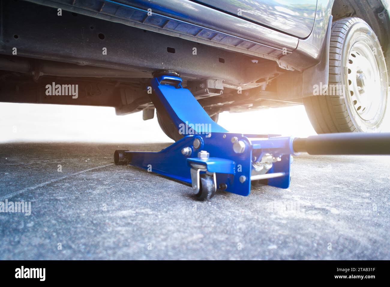 Lifting a pickup truck with a hydraulic floor jack for servicing and ...