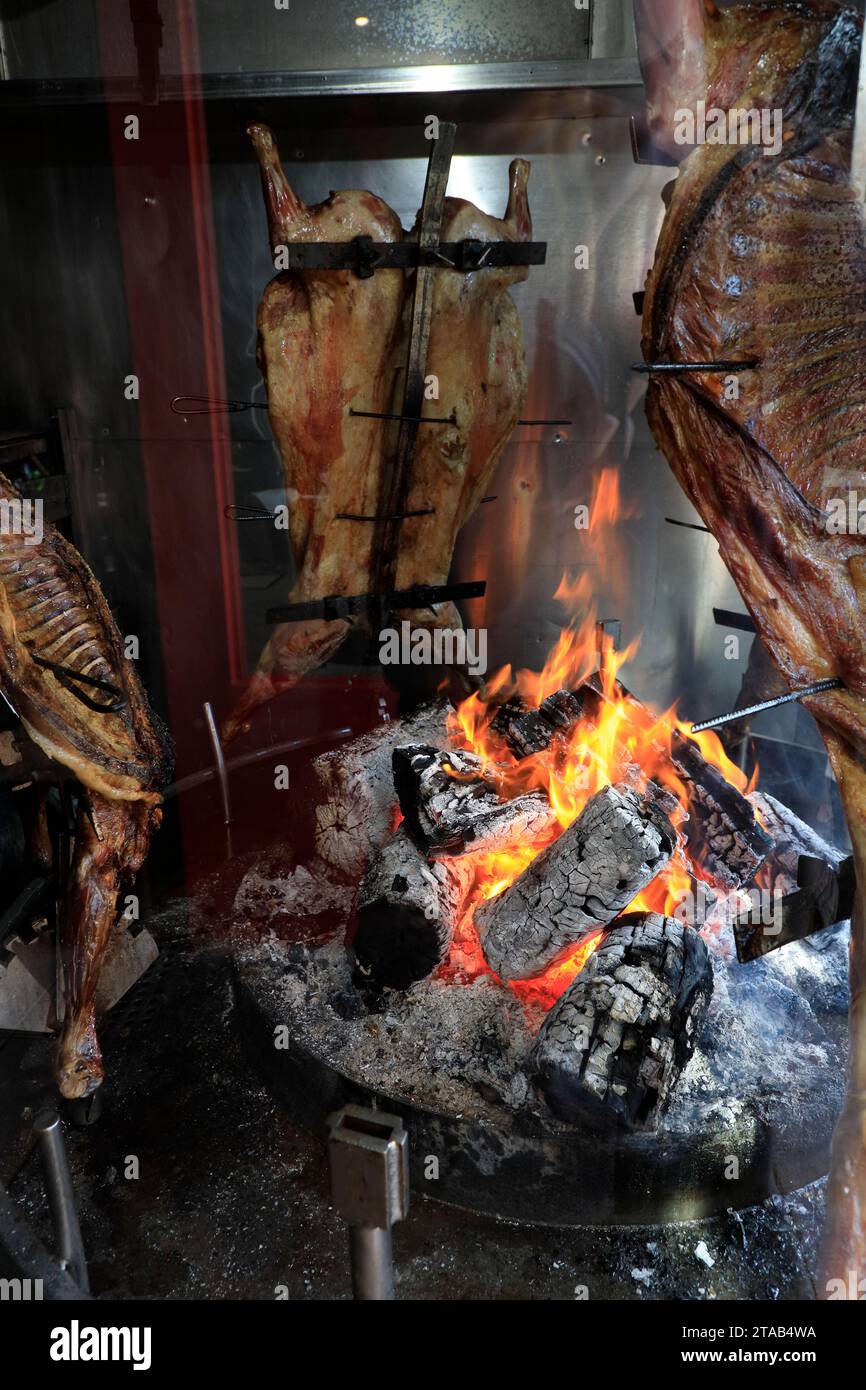 Traditional Asado- barbecue of a lamb preparing in a local restaurant ...
