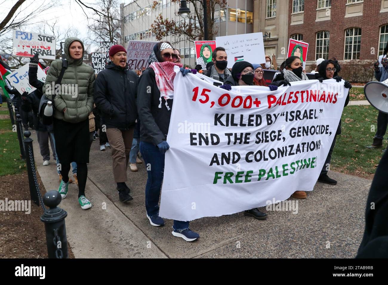 University Park, United States. 29th Nov, 2023. Demonstrators hold ...