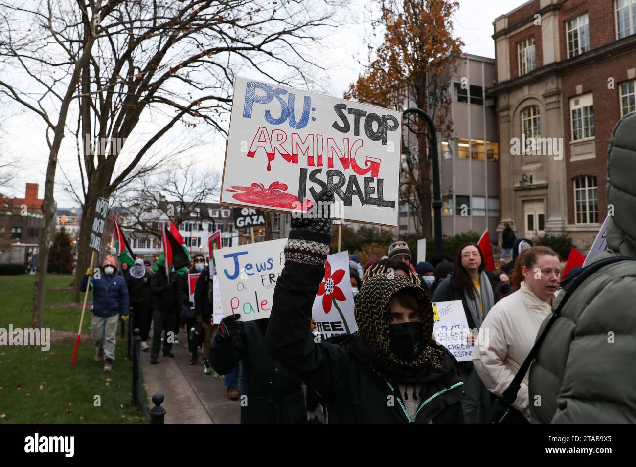 University Park, United States. 29th Nov, 2023. Demonstrators hold ...