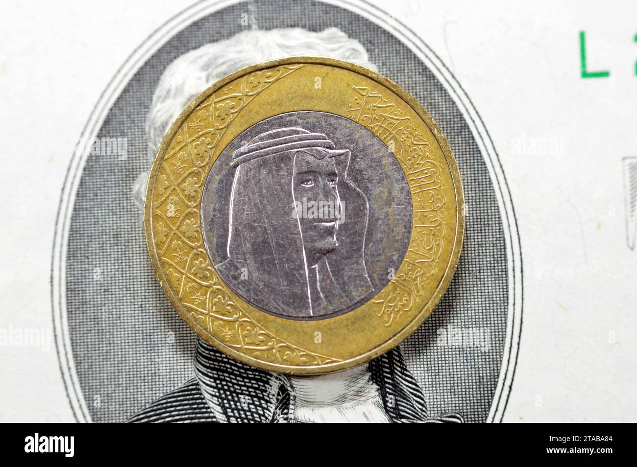 One Saudi Arabia riyal coin year 2016 on 2 American dollars USD paper ...