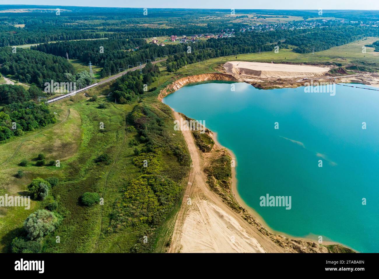 Aerial view of a flooded sand quarry with blue water Stock Photo - Alamy