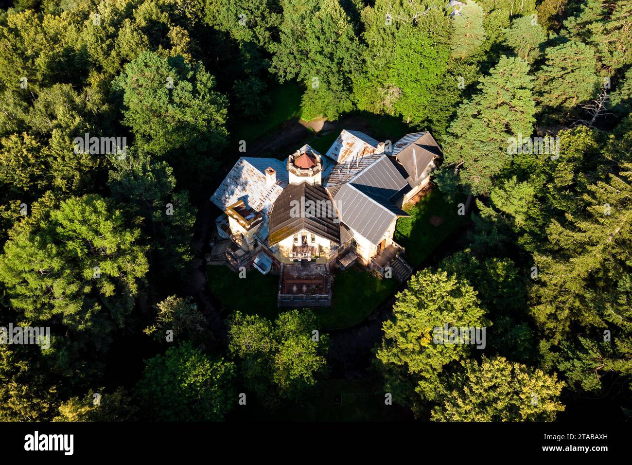 Landscape from above with a view of an old mansion among a green forest ...