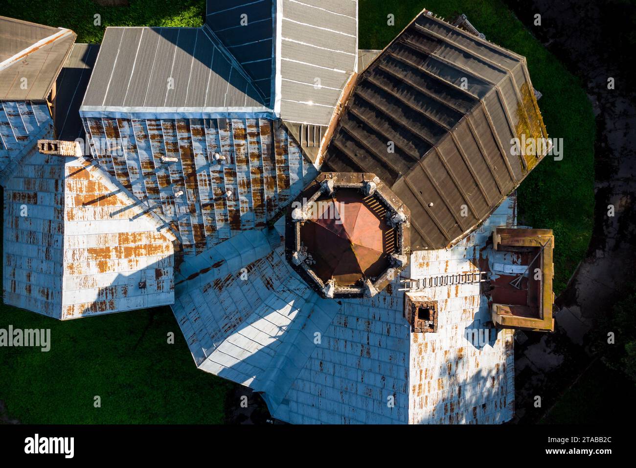Aerial view of the roof of an old manor house with a turret and spire ...