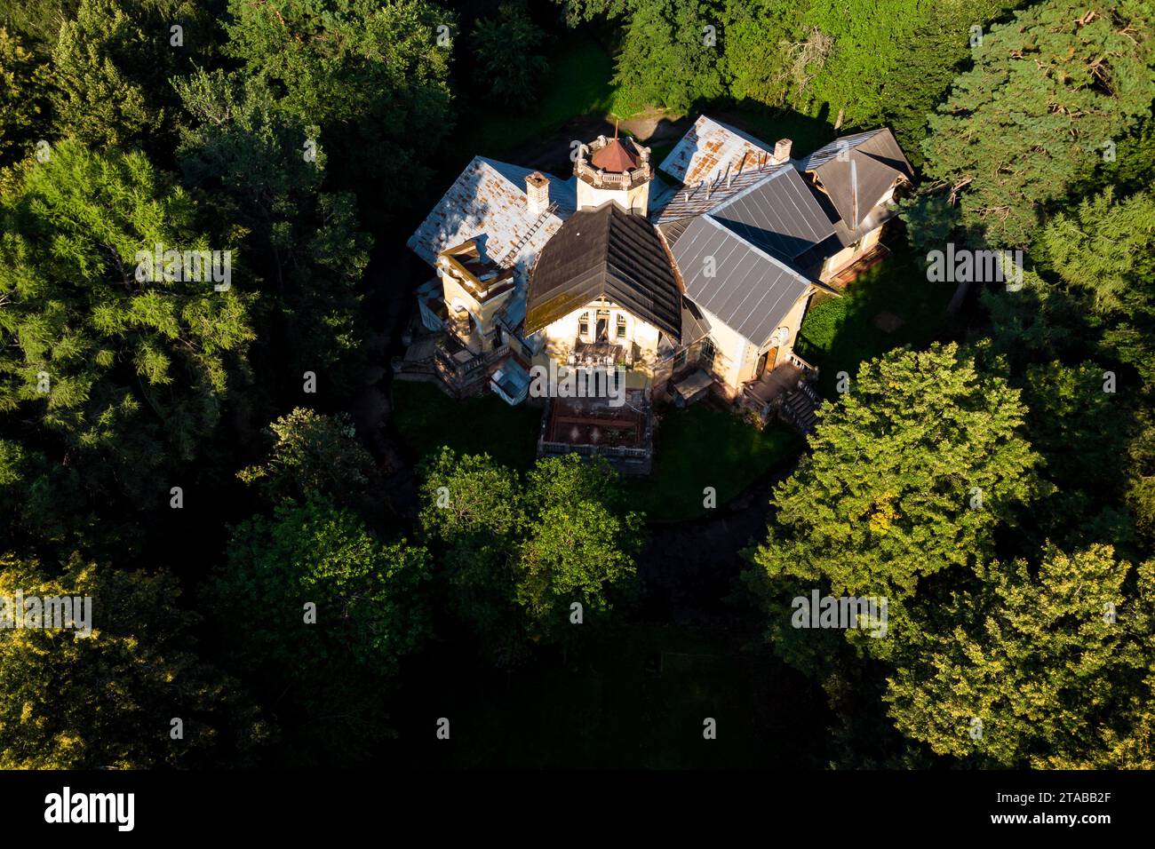 Landscape from above with a view of an old mansion among a green forest ...