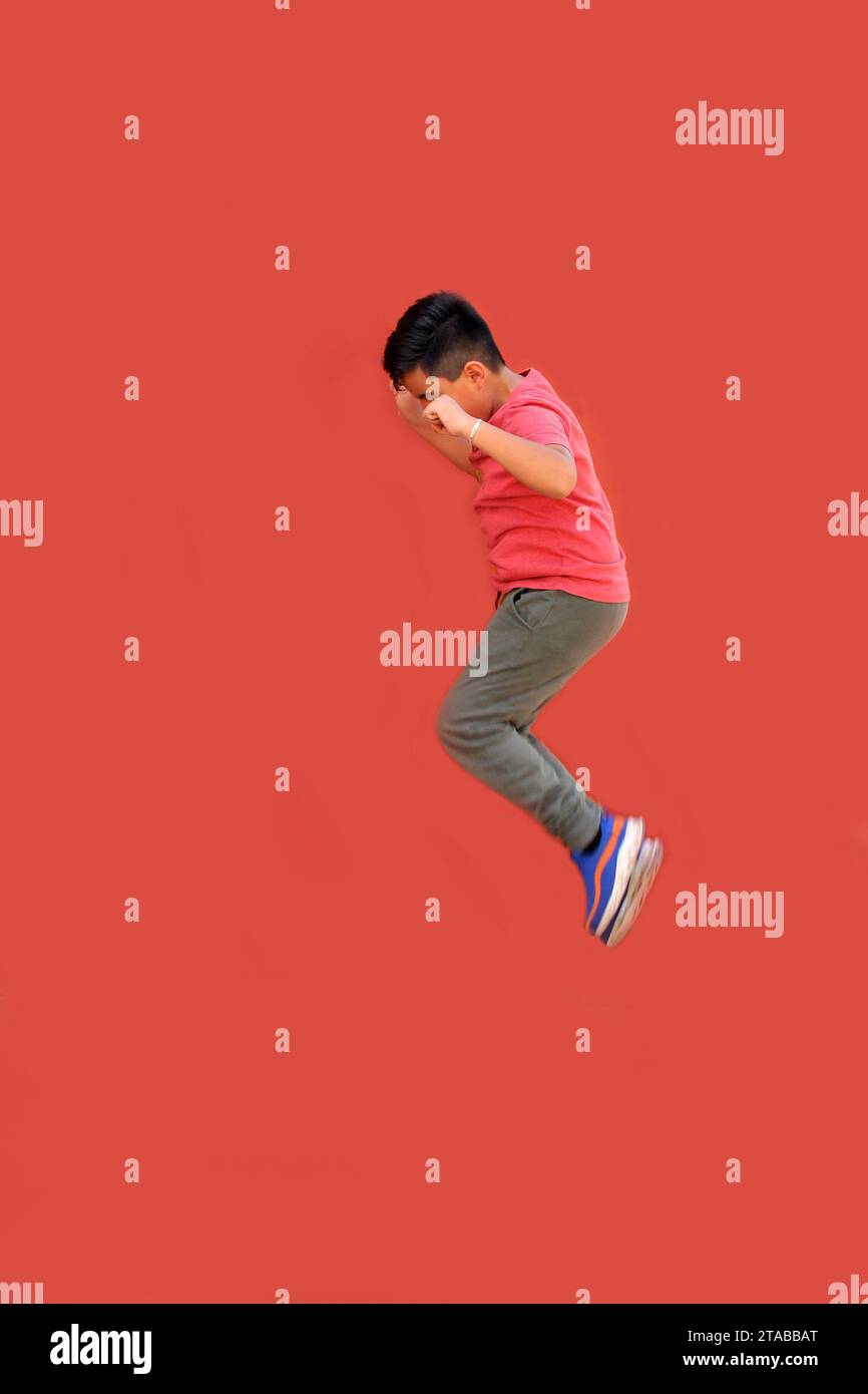 9-year-old Latino boy jumps and plays while doing physical activity to ...