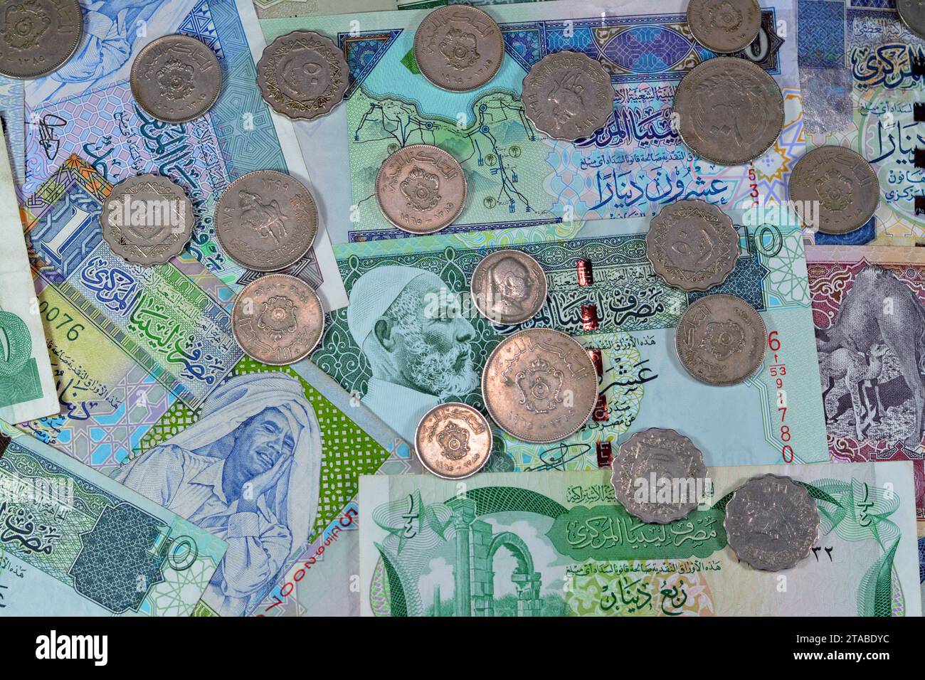 Background of old Libyan money banknote bills and coins of different ...