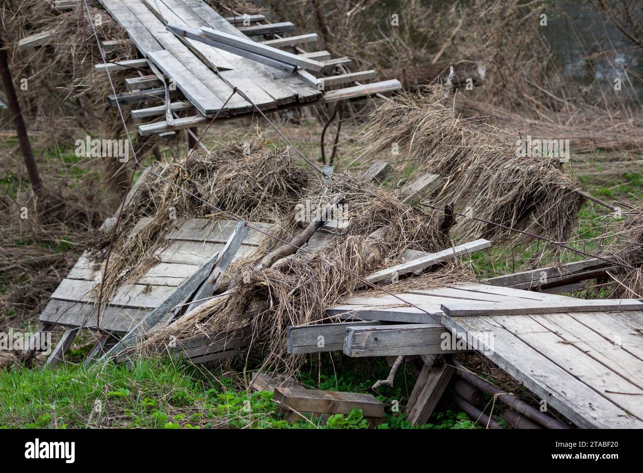A broken pedestrian suspension bridge in the countryside after a spring ...