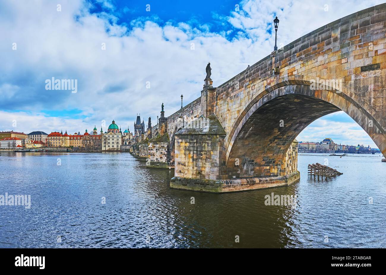 The medieval arched sculptured Charles Bridge across the Vltava River ...