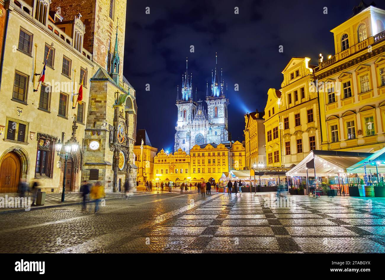The brightly illuminated Old Town Square with historic Tyn Church ...