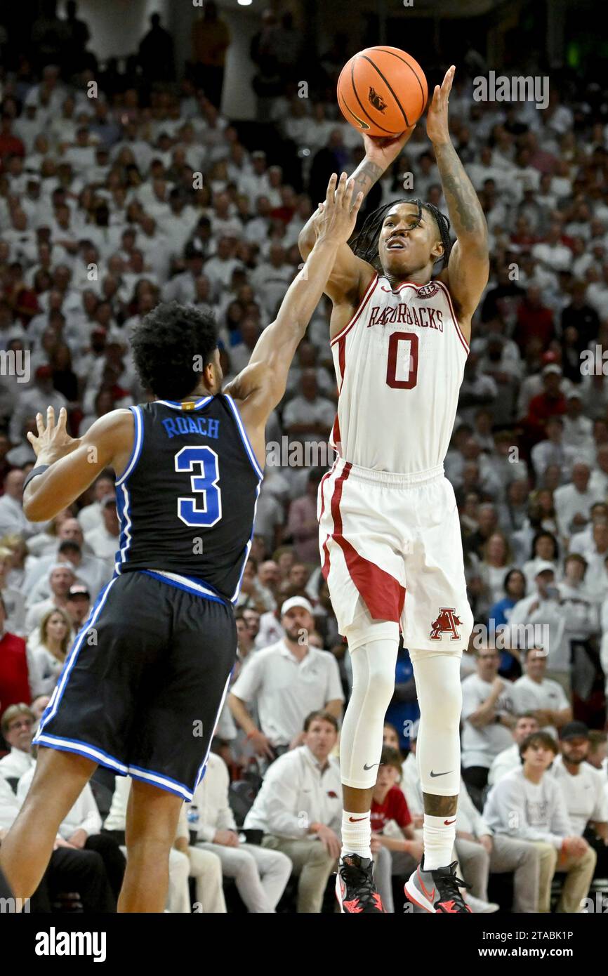 Arkansas guard Khalif Battle (0) is fouled by Duke guard Jeremy Roach (3) as he shoots a three ...
