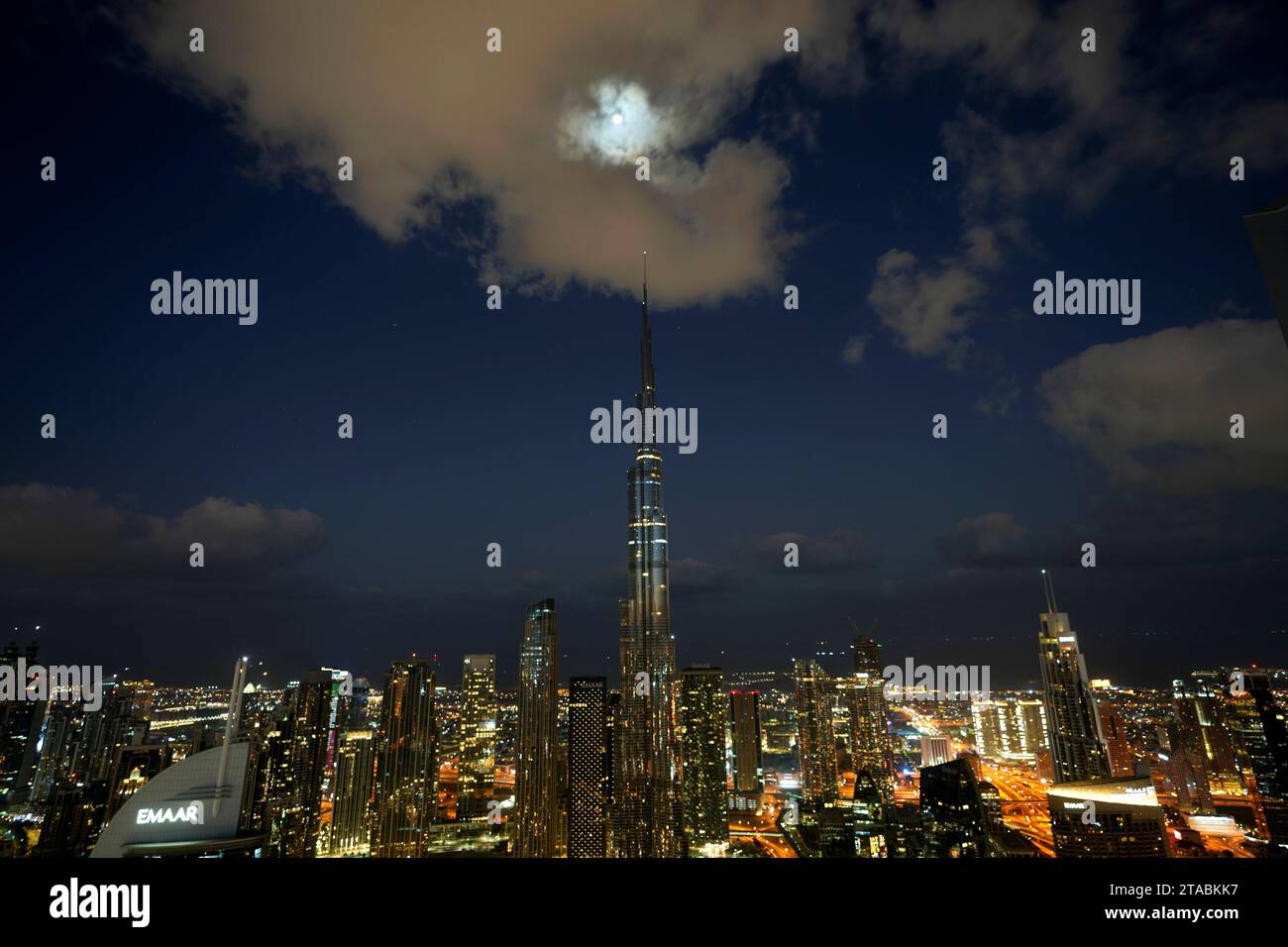 Moon rises over the Dubai city skyline with Burj Khalifa, the world's ...