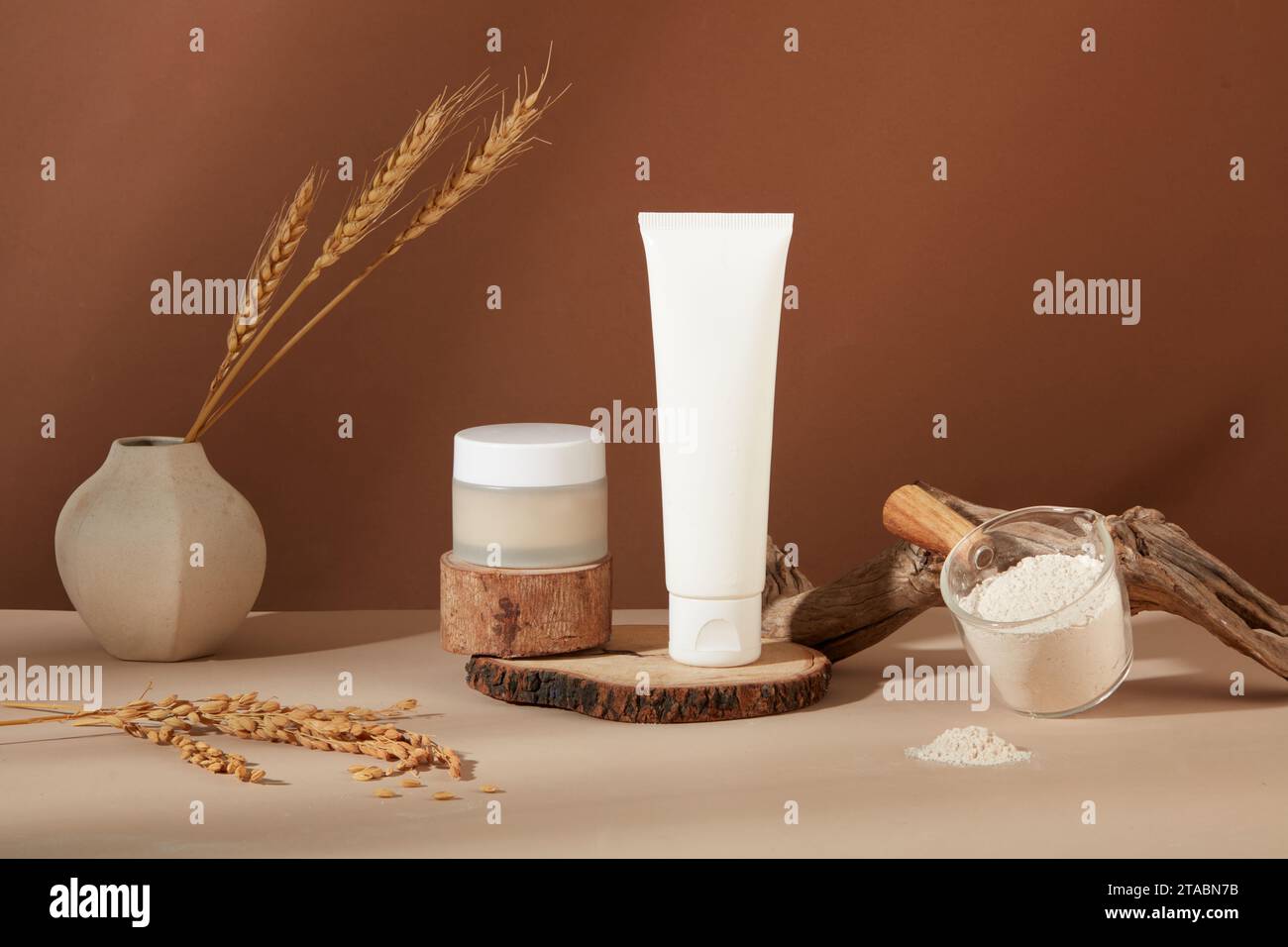 Rice bran powder is stored in a glass bowl. Set of skin care cosmetics ...