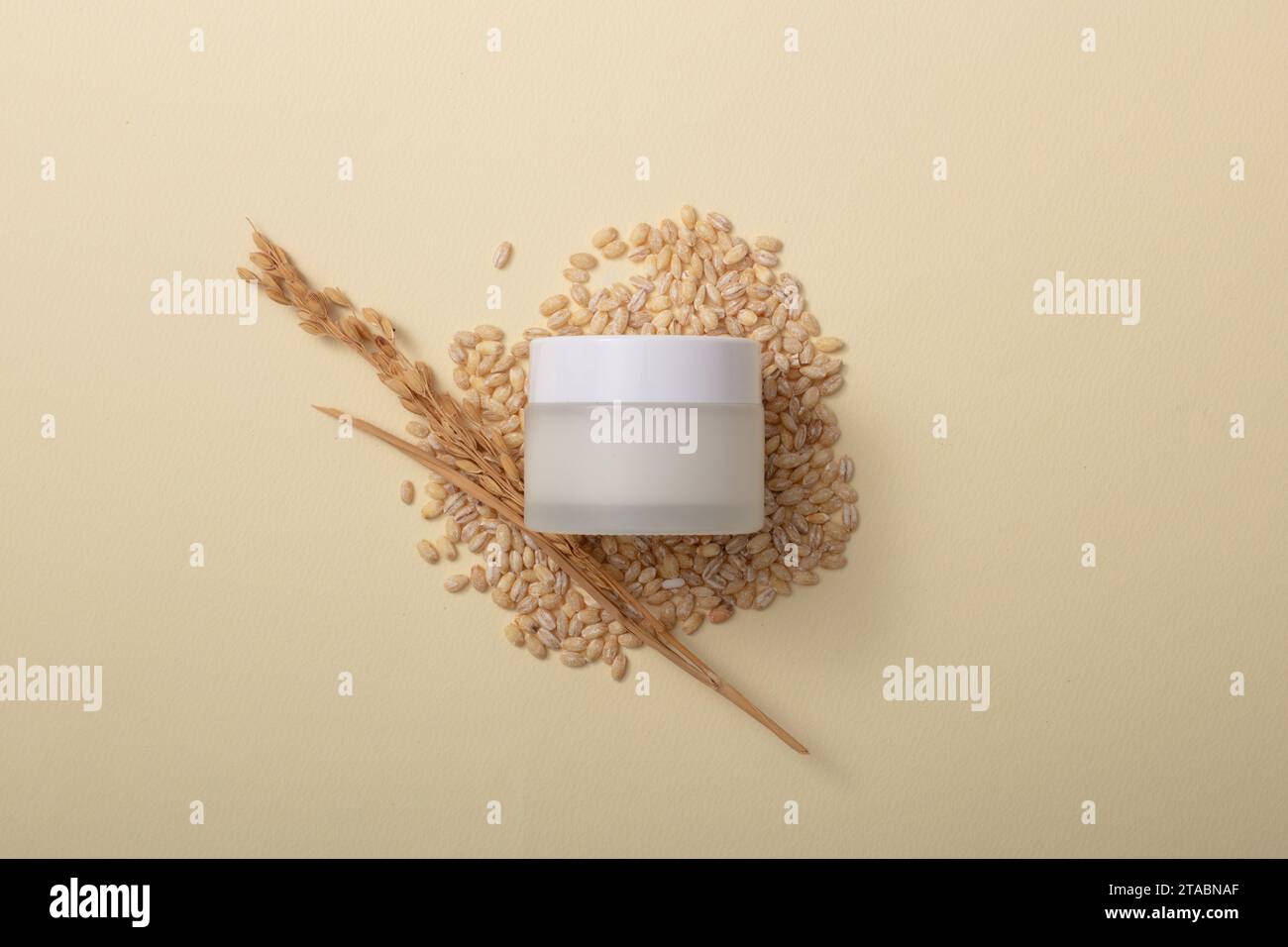 View from above of a cosmetic jar without label placed on rice bran ...