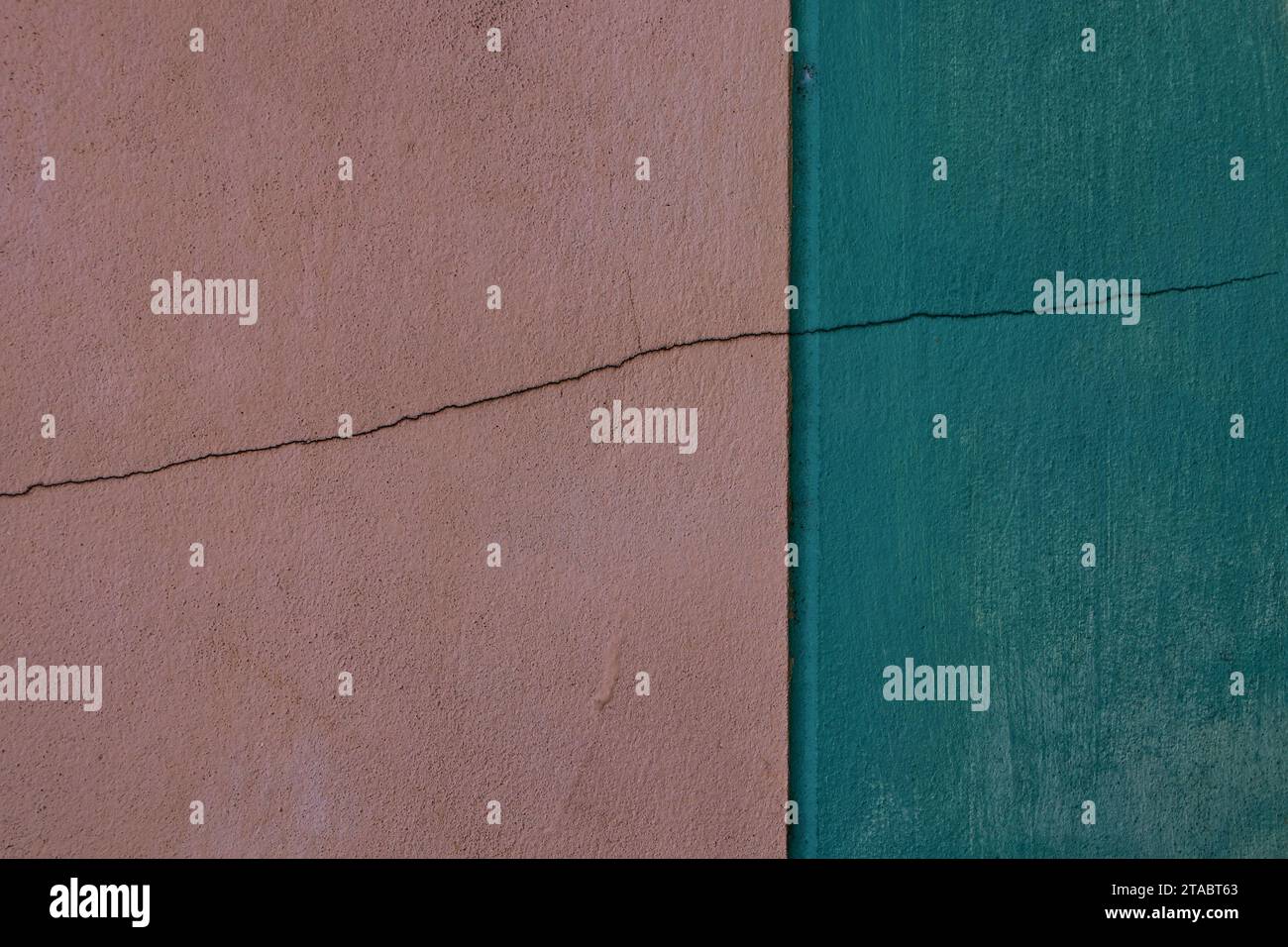 The building wall has a long crack. painted green and pink Stock Photo ...