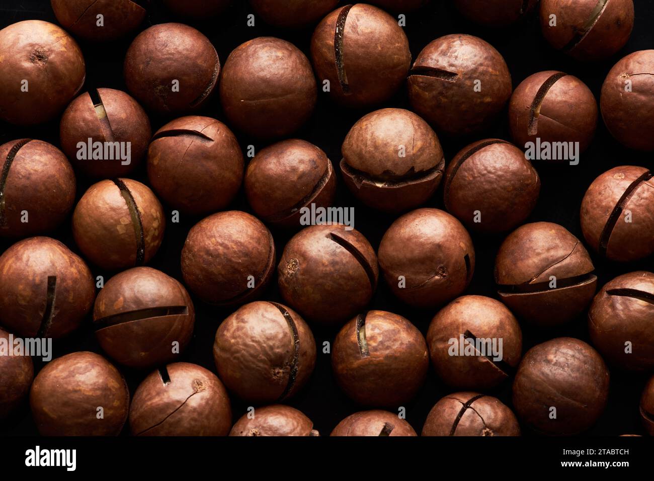 Macro top view of shelled roasted macadamia nuts in heap, food ...
