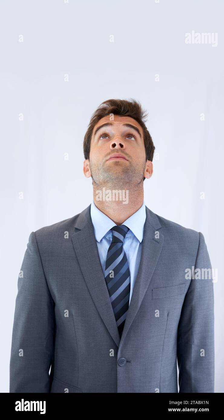 Thinking, looking up and business man on a white background for options ...