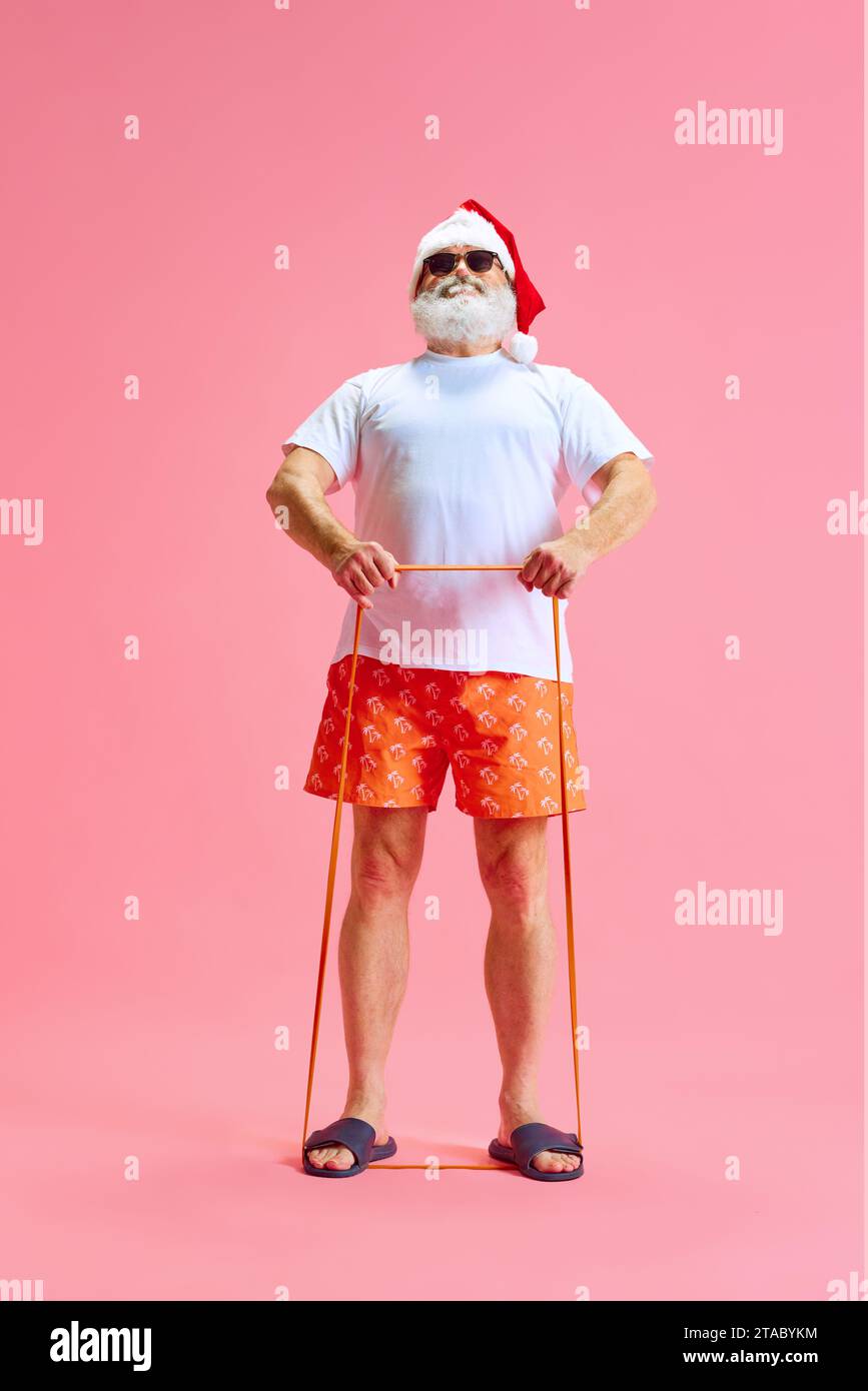 Full size portrait of Santa Claus dressed colorful pajama training hard ...