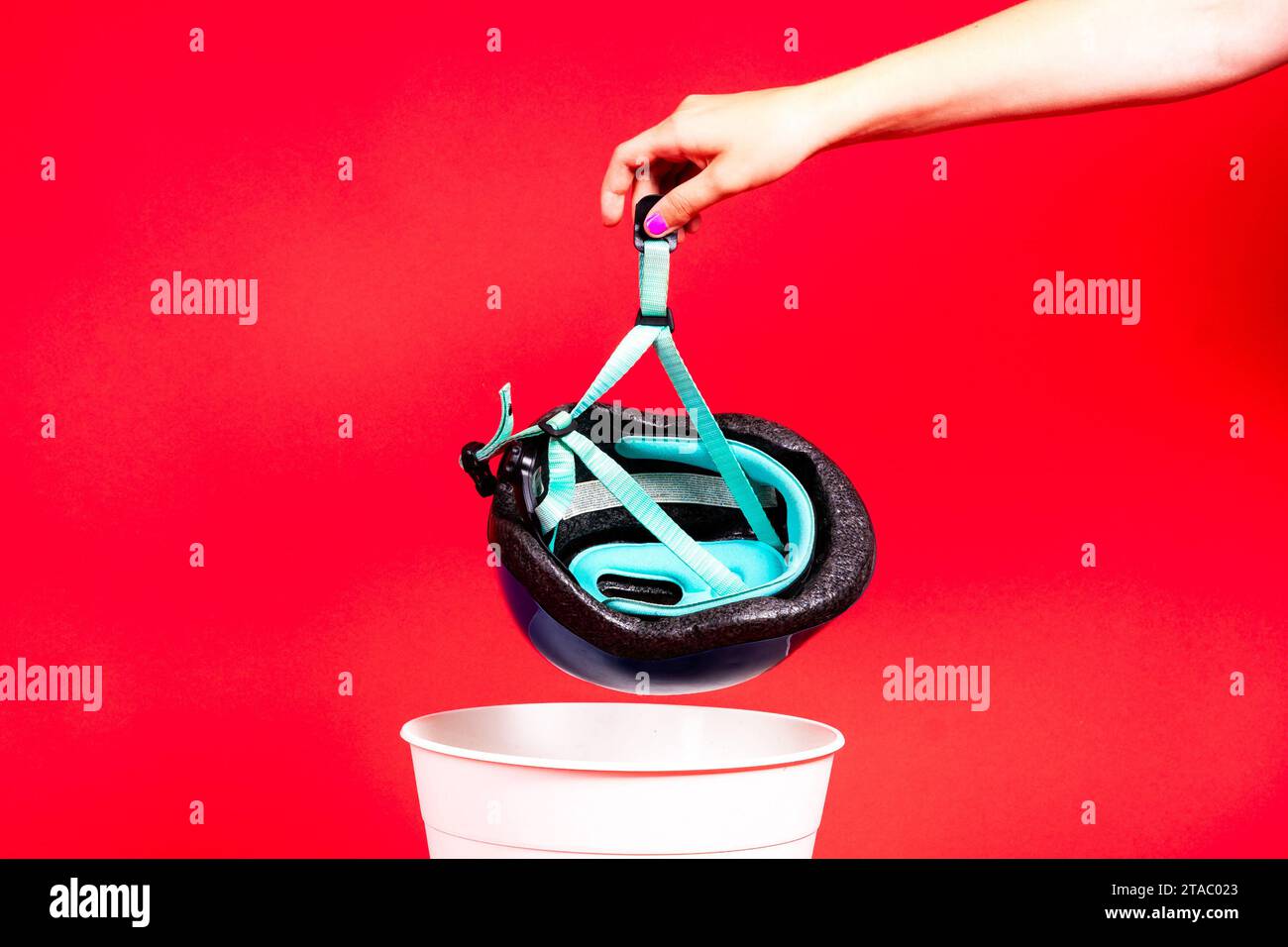 Photo of bike and engineer helmet in a plastic trash bin, studio shot ...