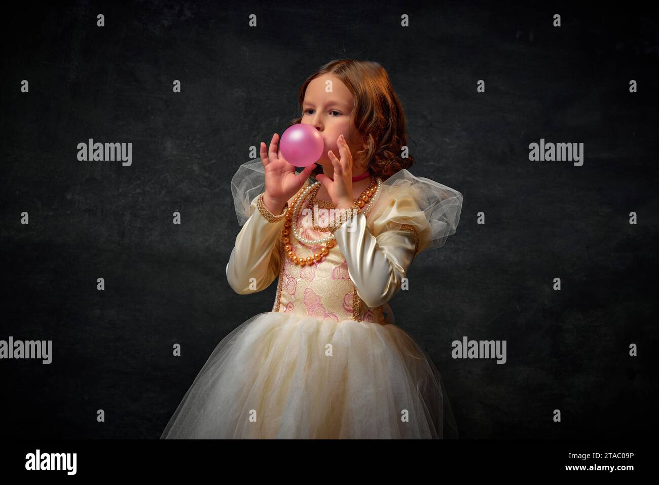 Portrait of little girl as princess against dark vintage background ...