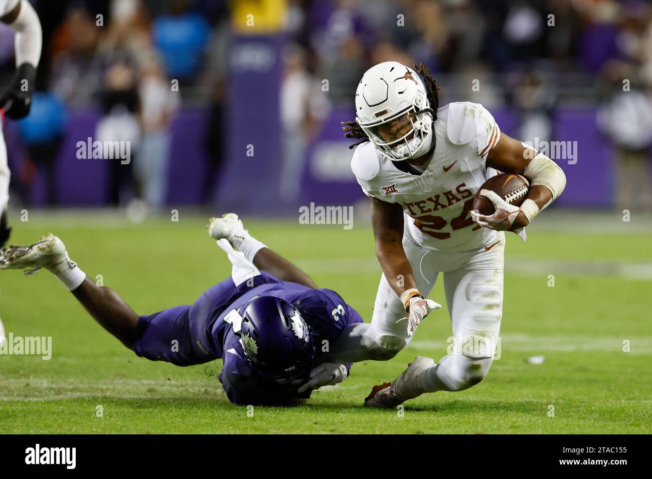 Texas running back Jonathon Brooks (24) gets tripped up and tackled by ...